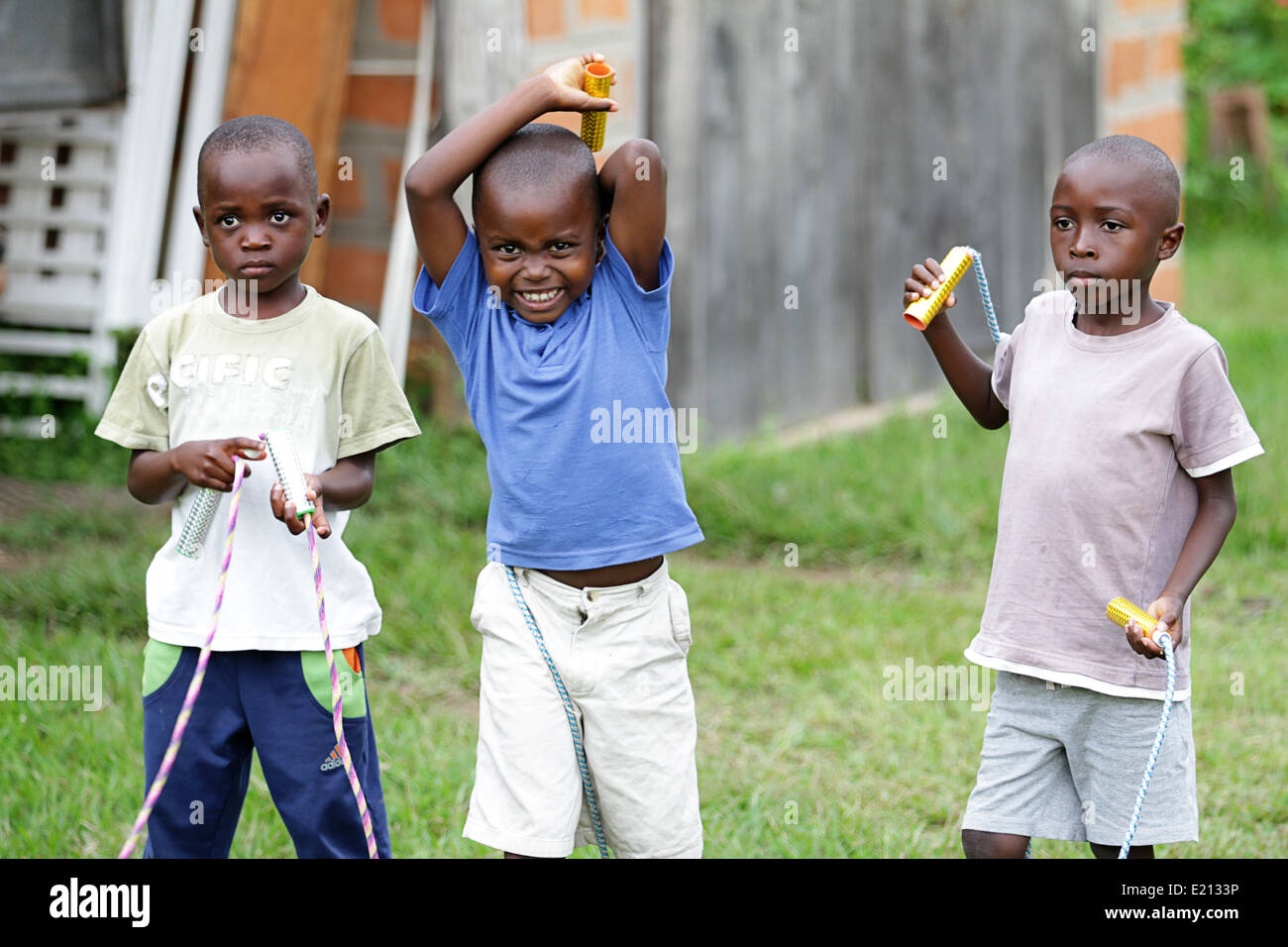 Three orphaned boy playing together with skipping ropes Stock Photo - Alamy