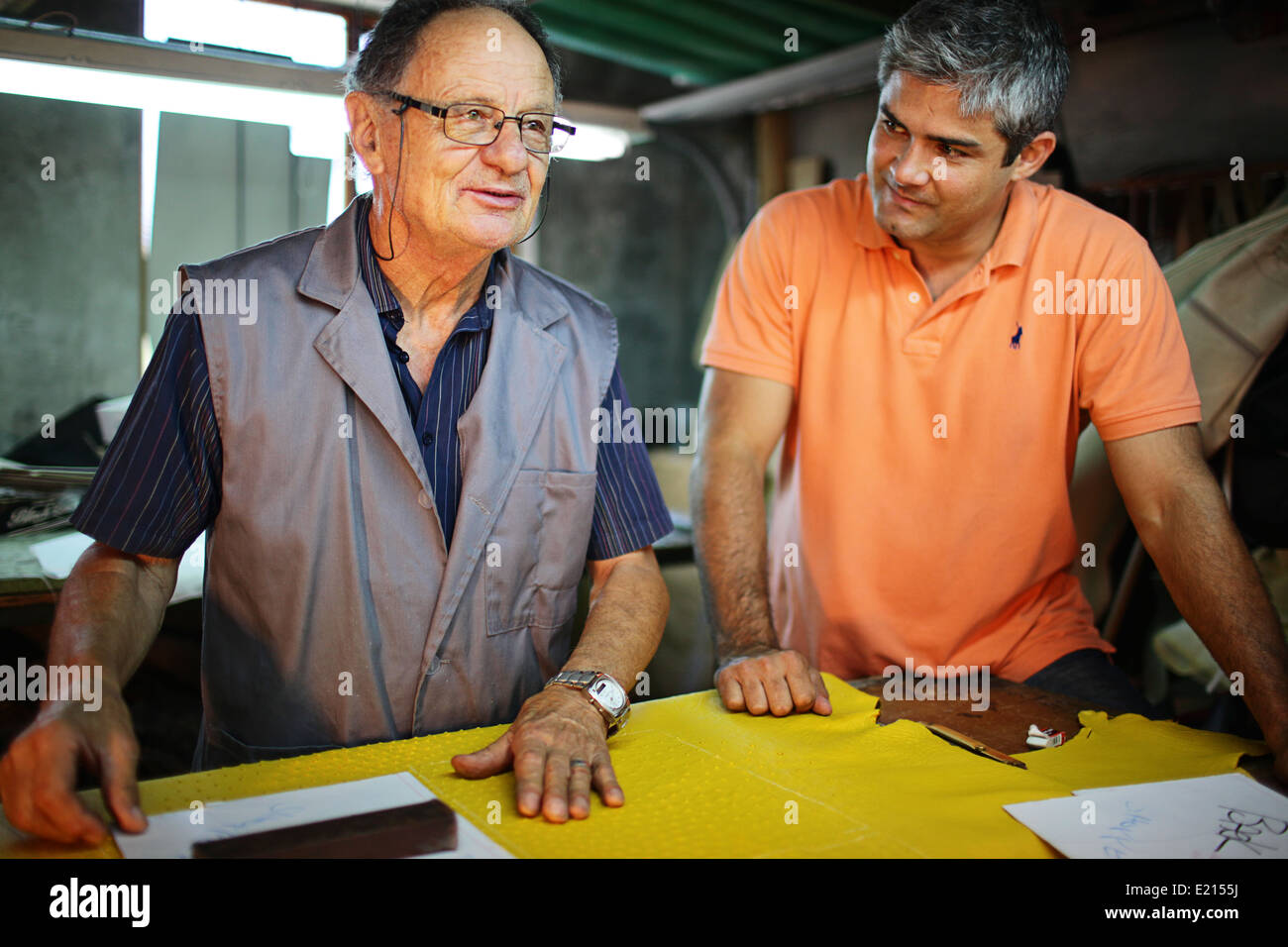 Elderly Italian father and middle aged son pose for a family photo in ...
