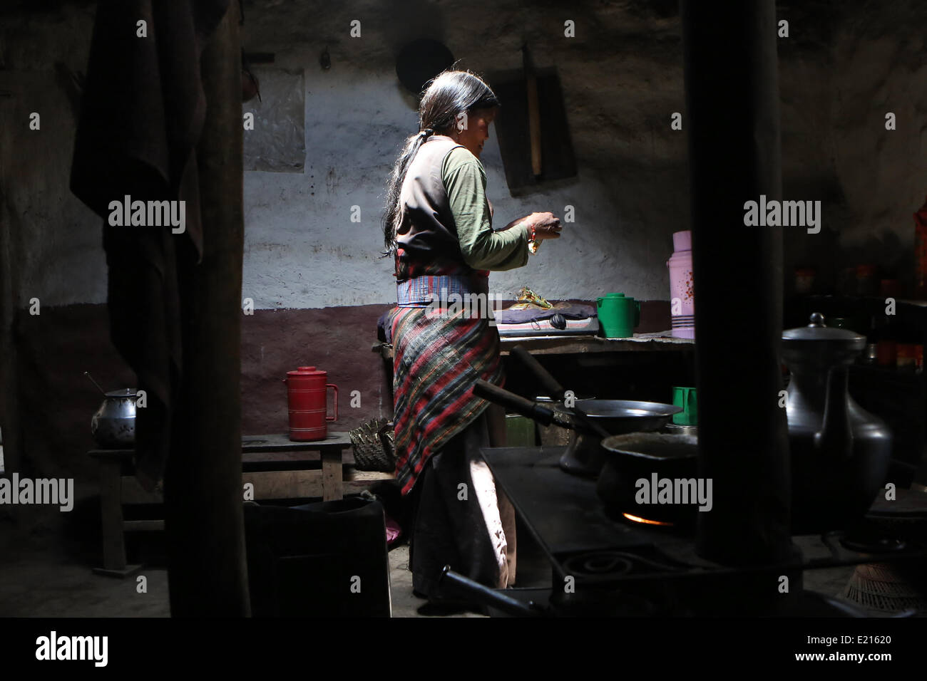 Dhe, Mustang, Nepal. 21st May, 2014. A Loba woman prepares food in her ...