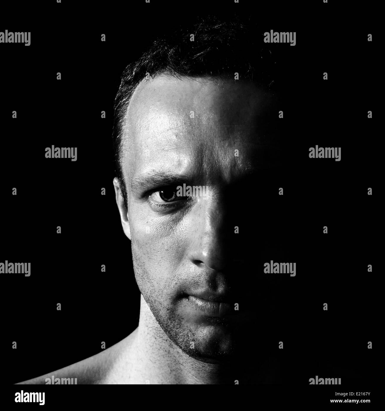 Young serious Caucasian man closeup portrait on black background Stock ...