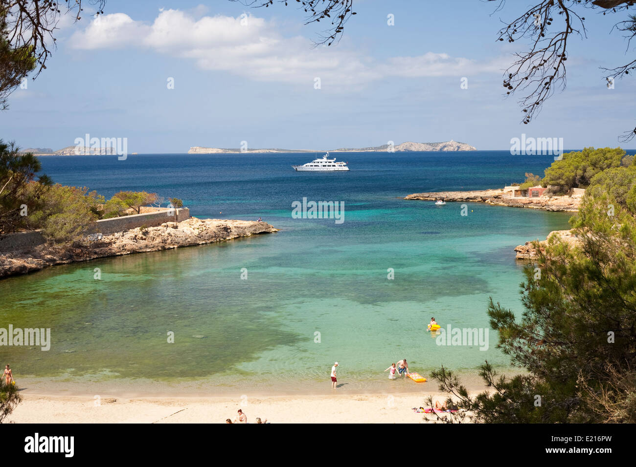 secluded bay in ibiza with crystal clear turquoise waters in the ...