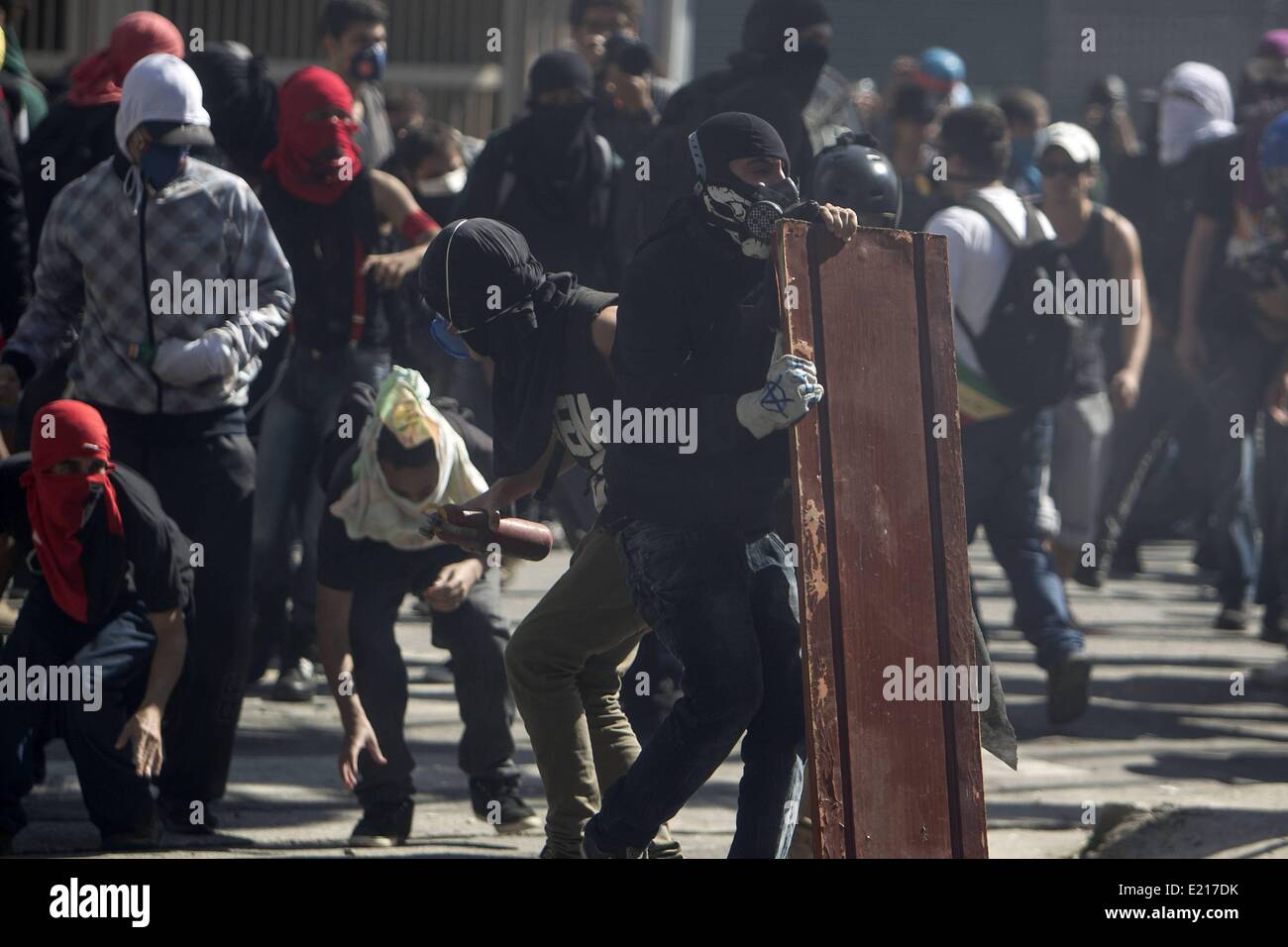 Sao Paulo, Brazil. 12th June, 2014. A demonstrator stands behind a ...