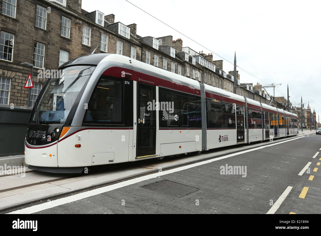 A tram carriage for Edinburgh Trams in operation on a street in ...