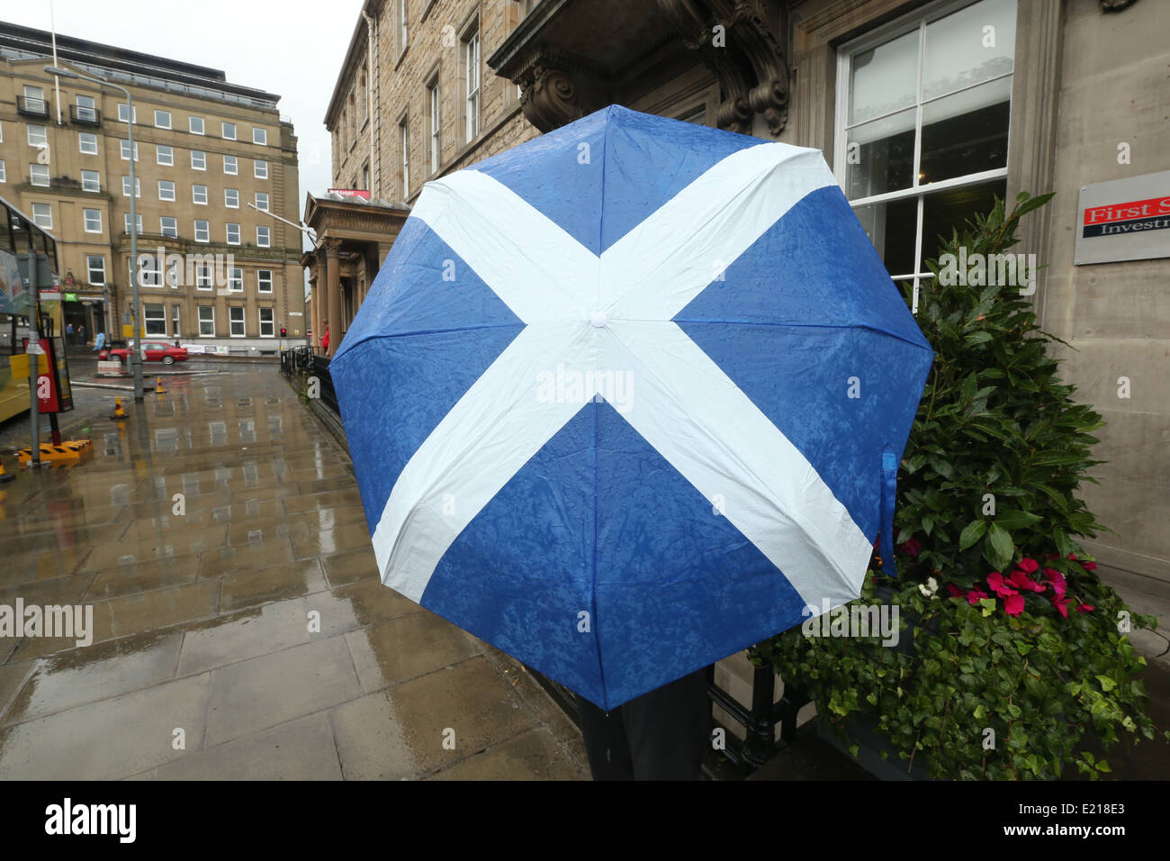 A person holds an Scottish umbrella in Edinburgh, Scotland during the ...