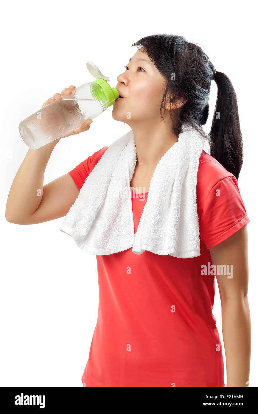Fitness woman drinking water on white background Stock Photo - Alamy