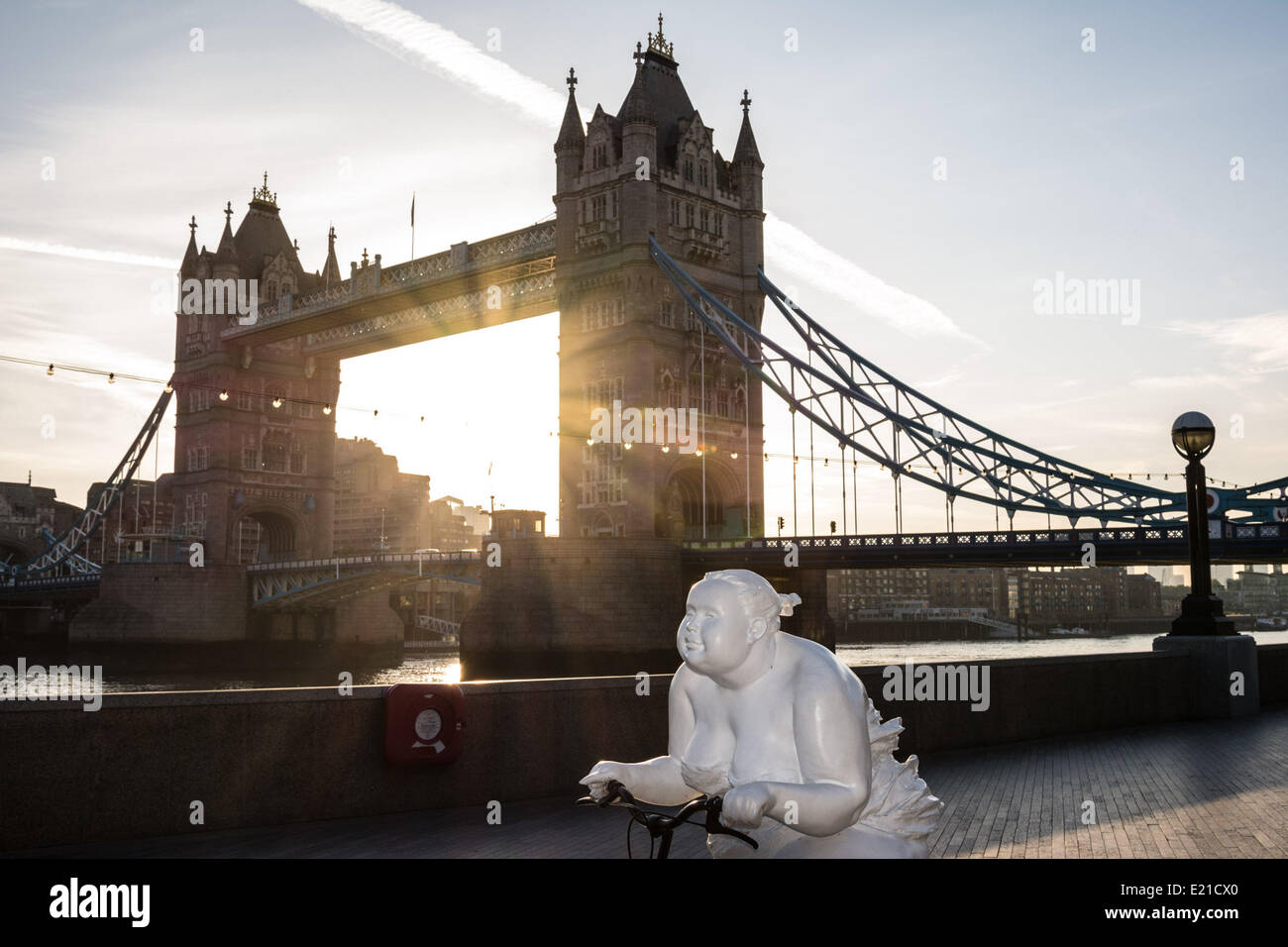 London, UK 13th June, 2014. Tower Bridge and the rising sun form the ...
