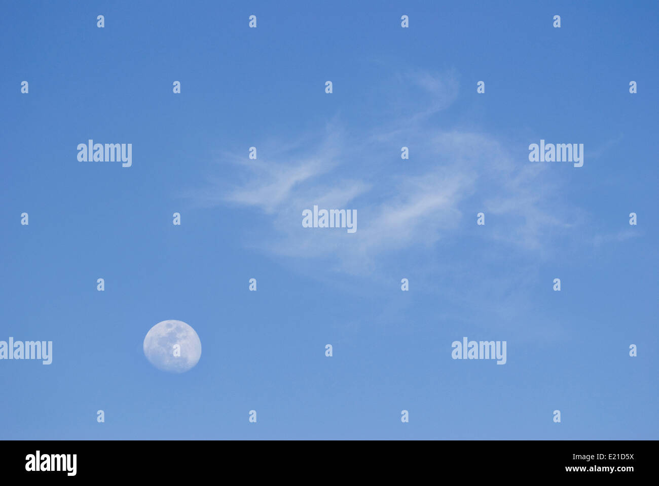 Moon and soft clouds in evening sky Stock Photo - Alamy
