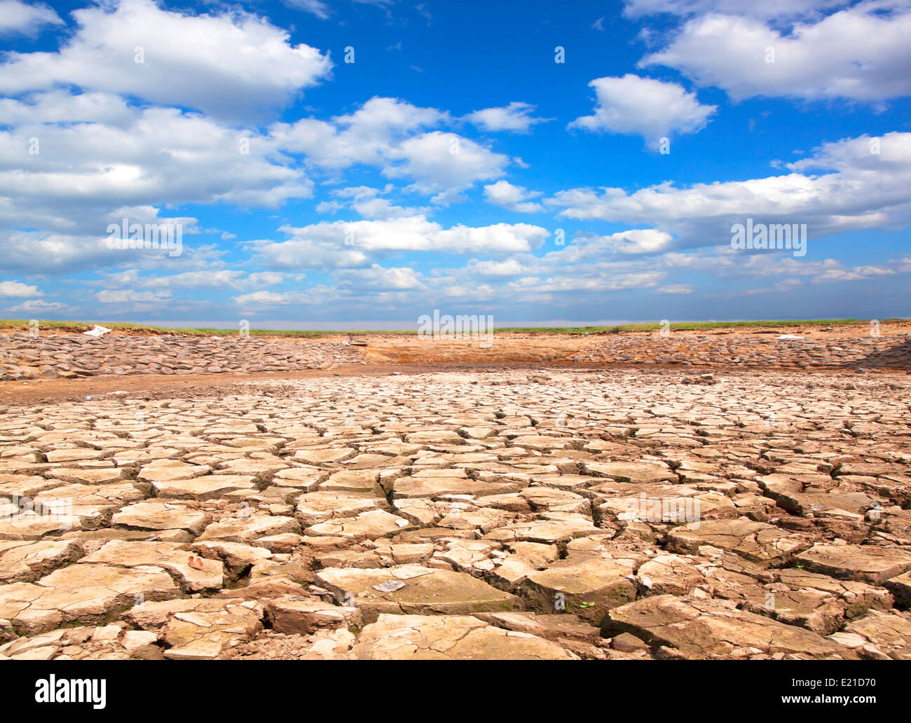 Drought land against a blue sky with clouds Stock Photo - Alamy