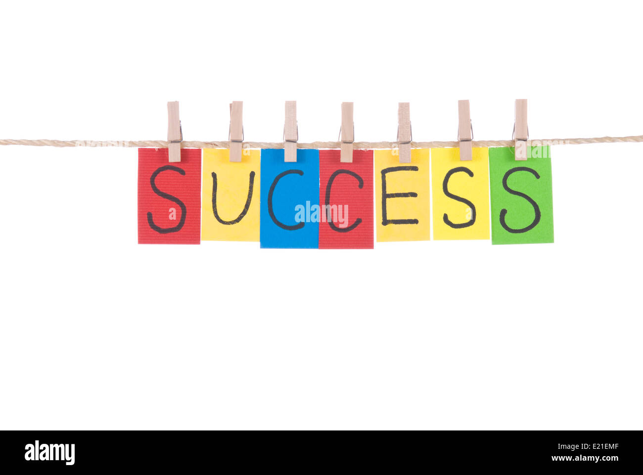 Success, words hang by wooden peg Stock Photo - Alamy