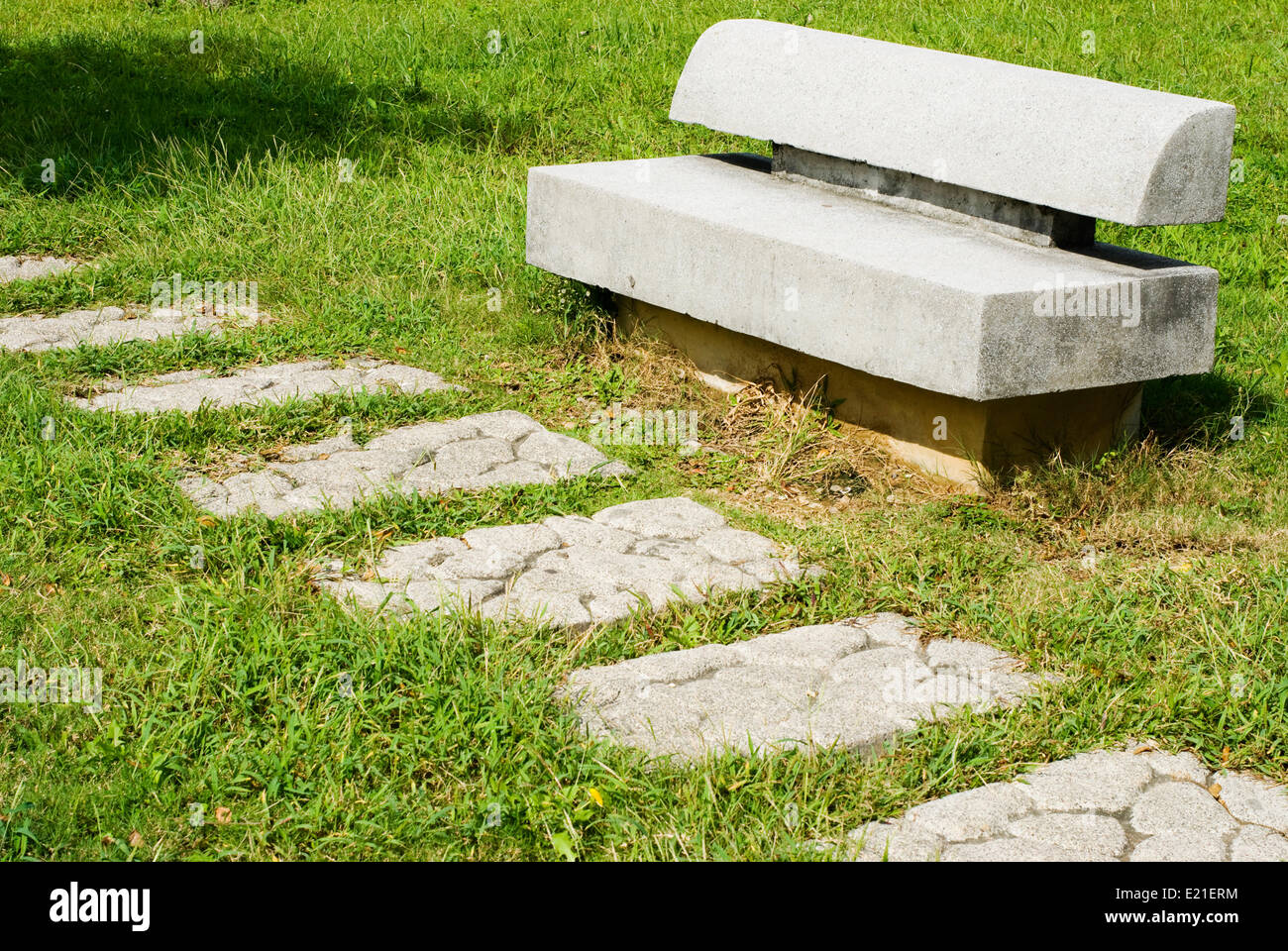 Stone walkway and stone bench Stock Photo - Alamy