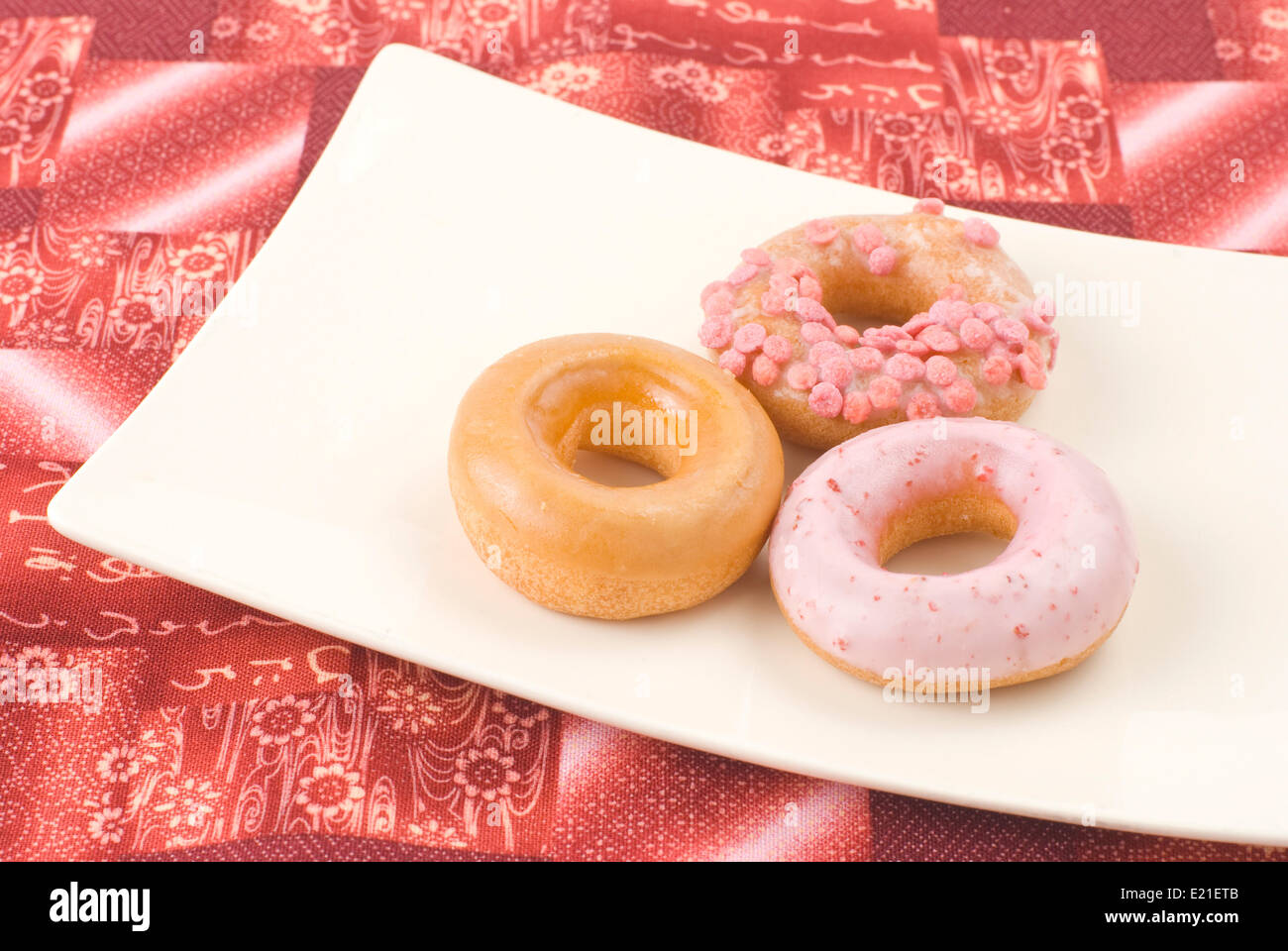 Colorful and delicious donut in plate Stock Photo - Alamy