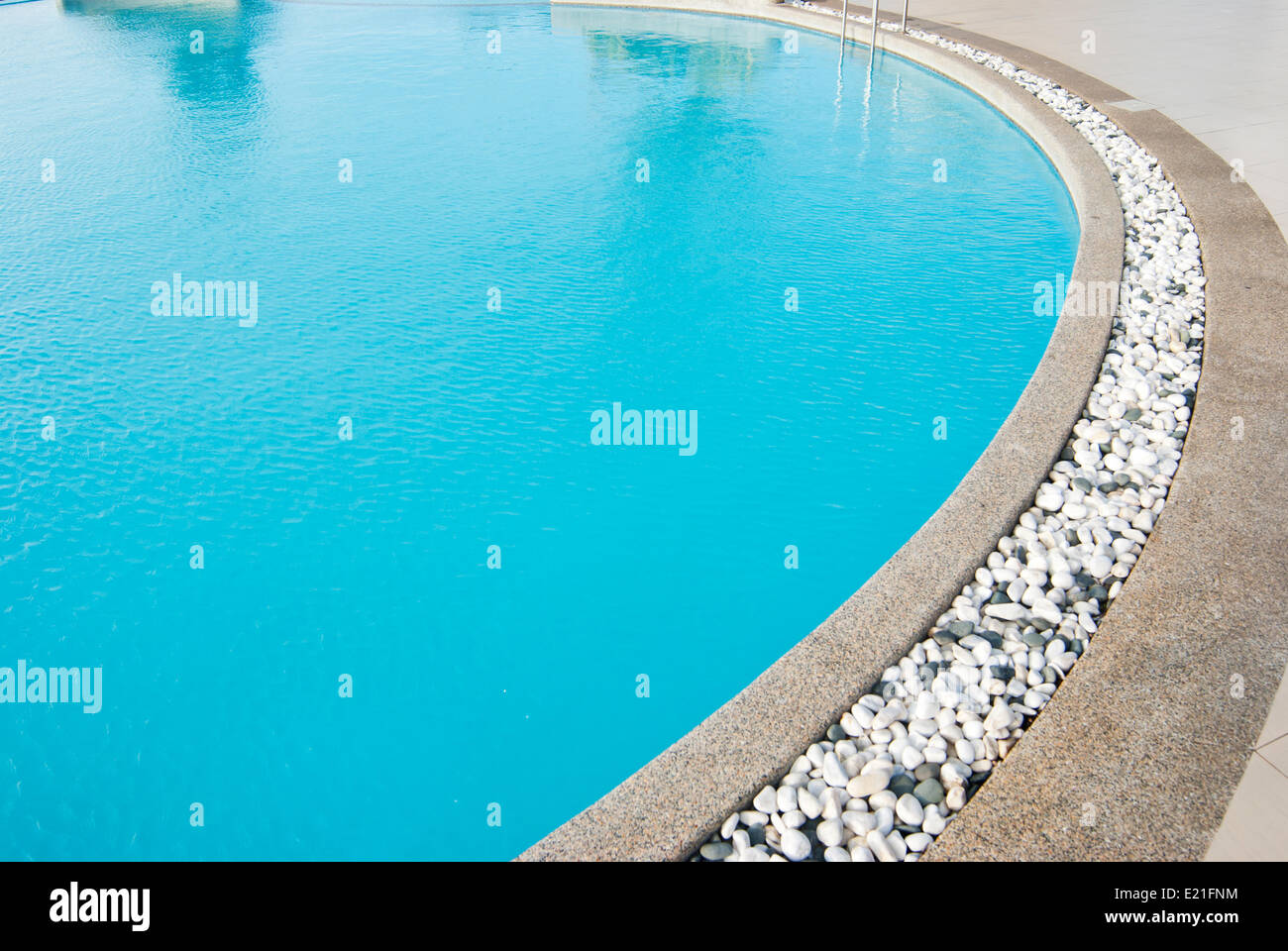 Swimming pool with white pebbles Stock Photo - Alamy