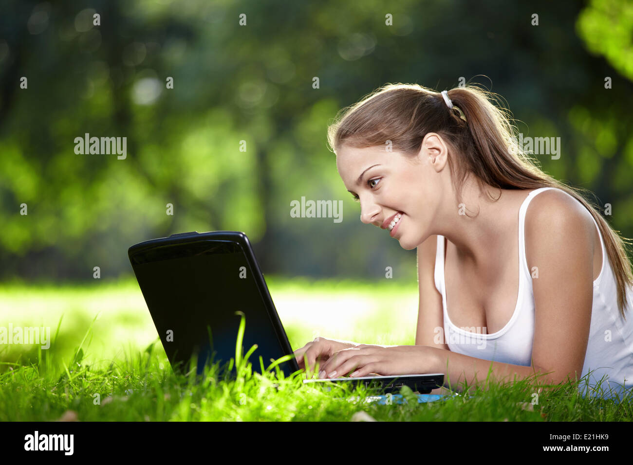 Girl with a laptop in the park Stock Photo - Alamy