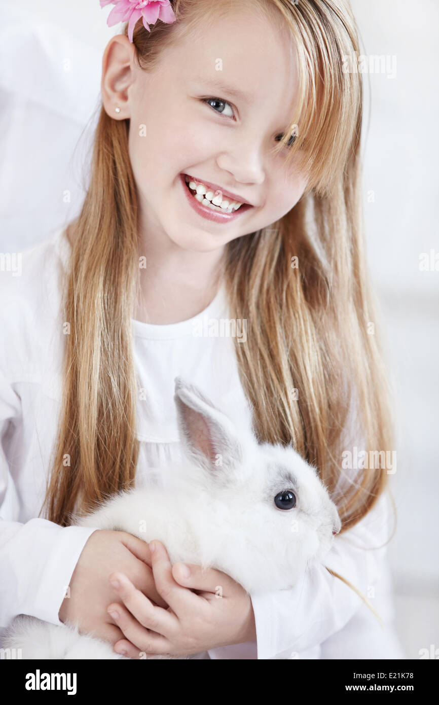 The little girl holding a white rabbit Stock Photo - Alamy