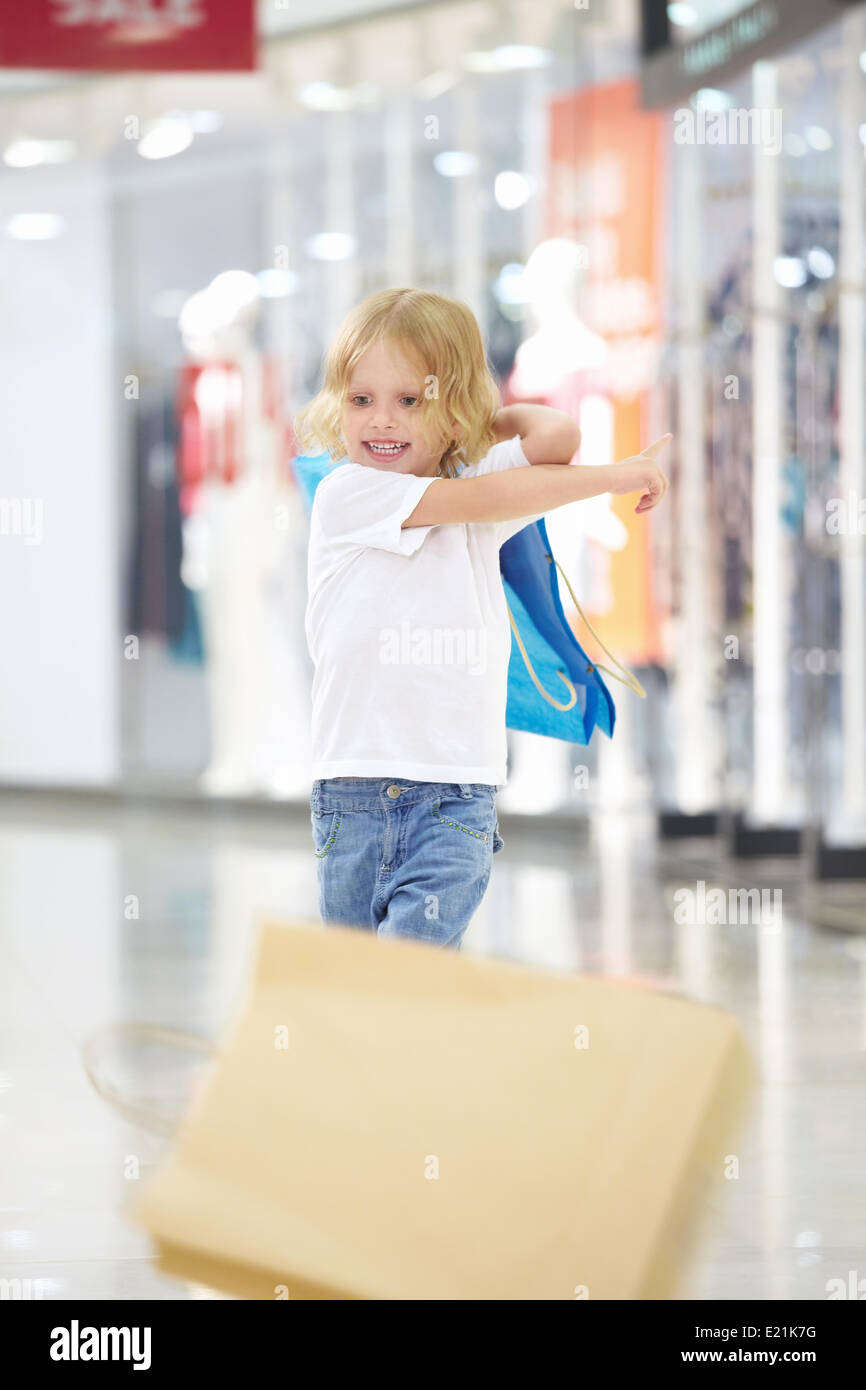 Little girl throws away from shopping bags Stock Photo - Alamy
