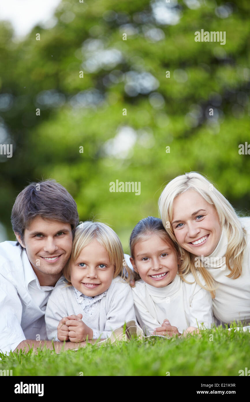 Smiling family with two children outdoors Stock Photo - Alamy