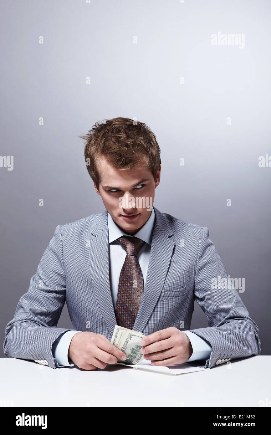 A young man counts the money Stock Photo - Alamy