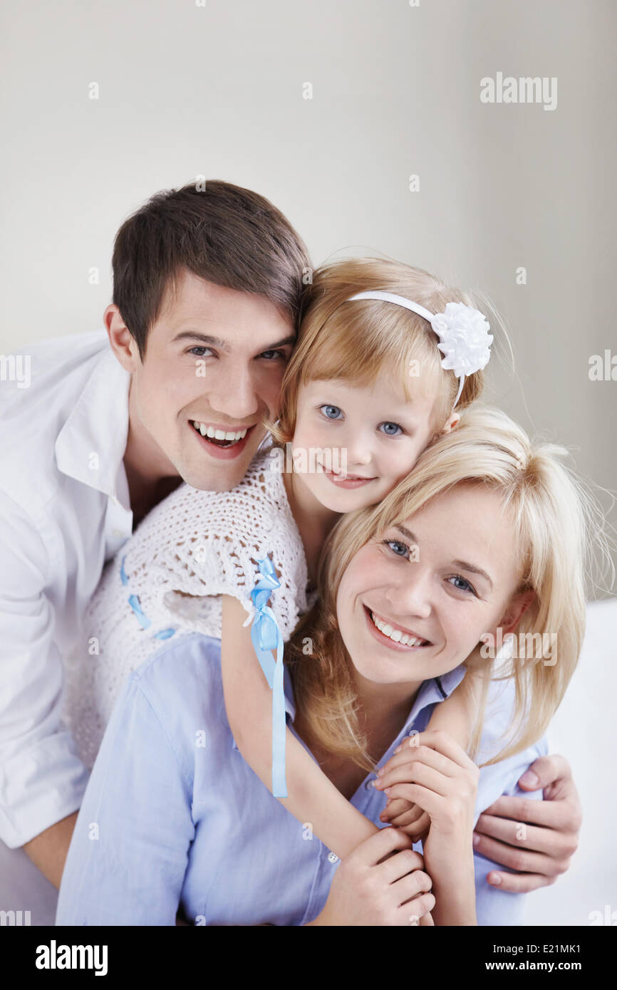 Portrait of a happy family of three Stock Photo - Alamy