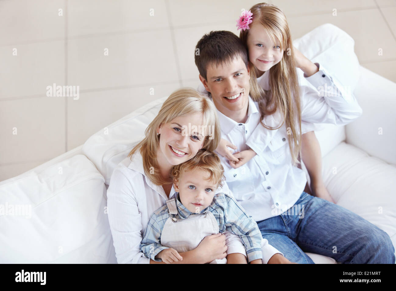 Young happy family with two children Stock Photo - Alamy