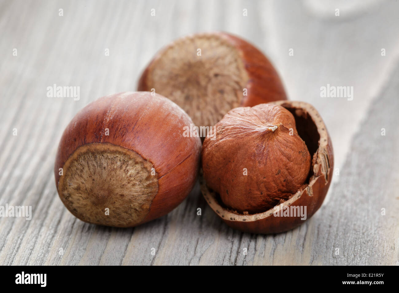 close up open and whole hazelnuts on wood table Stock Photo - Alamy