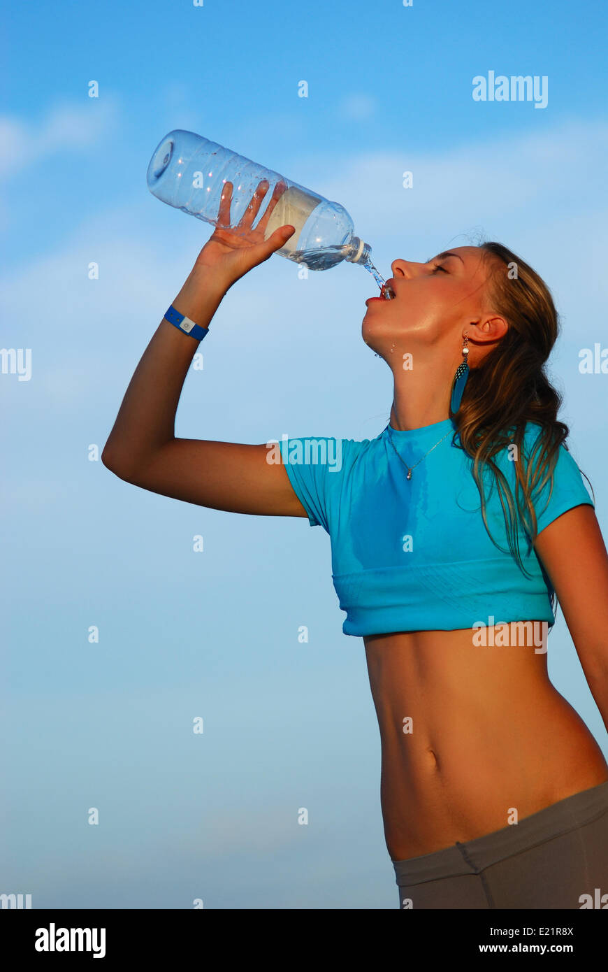 Drinking water after jogging Stock Photo - Alamy