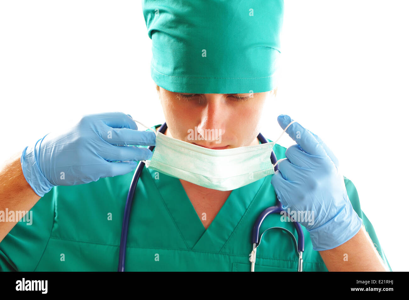 Pulling on surgical mask Stock Photo - Alamy