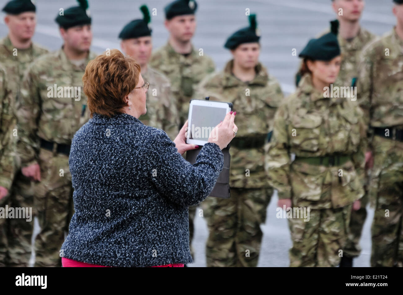 Woman uses an iPad to photograph or video a military parade Stock Photo ...