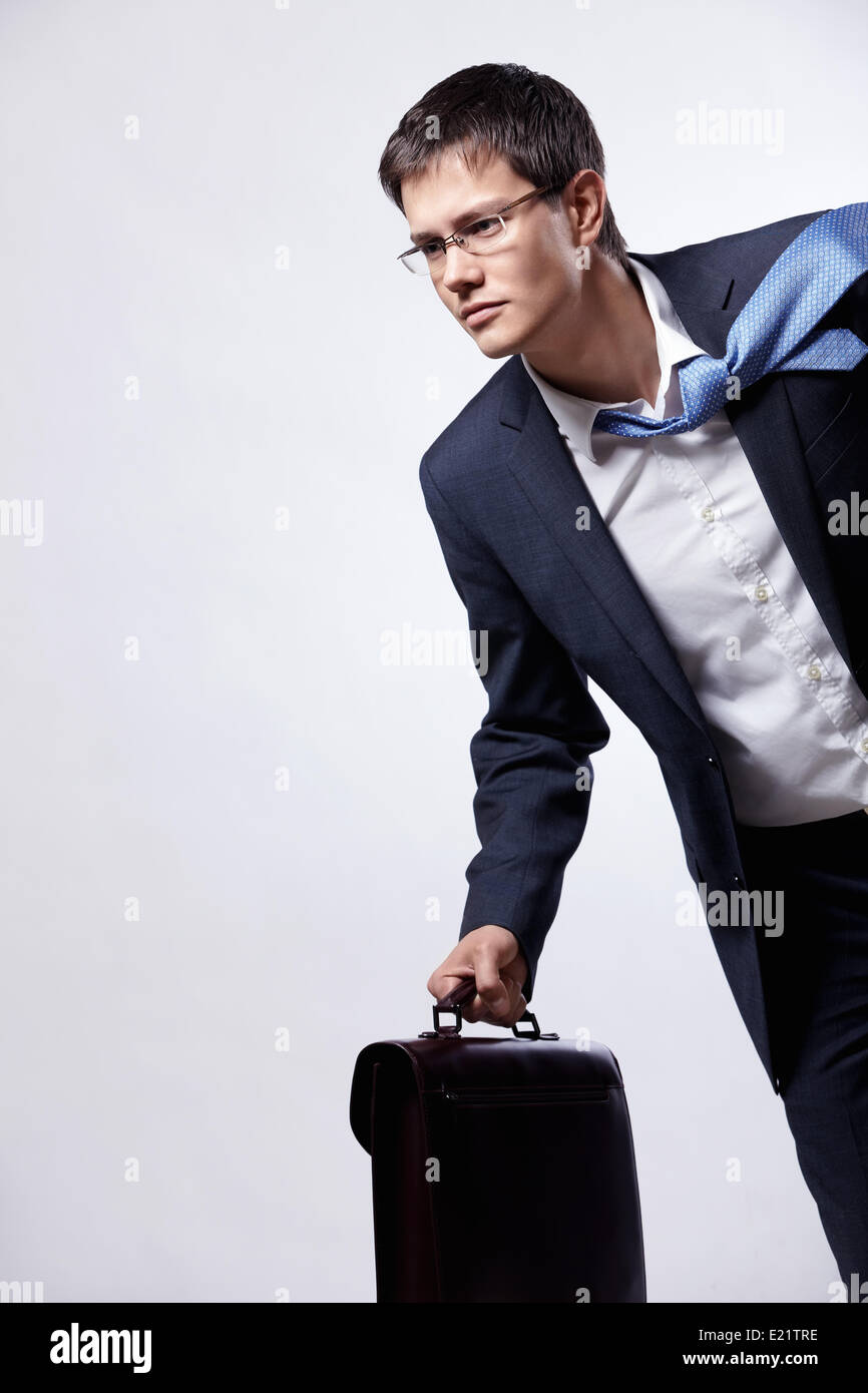 A young man running with a briefcase Stock Photo - Alamy