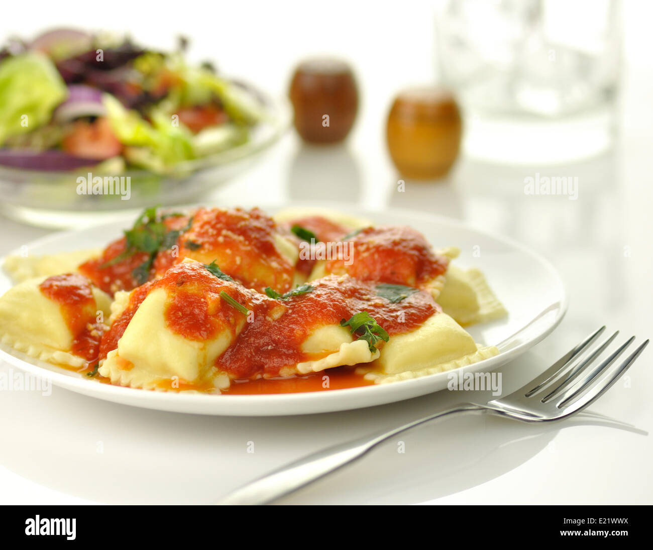 Ravioli pasta with red tomato sauce Stock Photo - Alamy