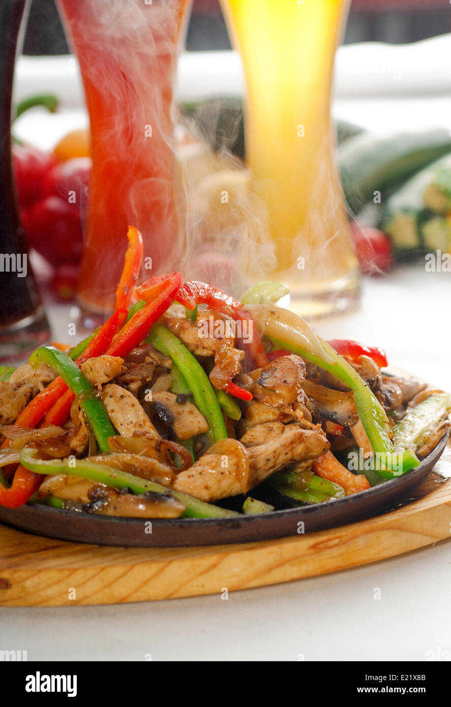 original fajita sizzling hot on iron plate Stock Photo - Alamy