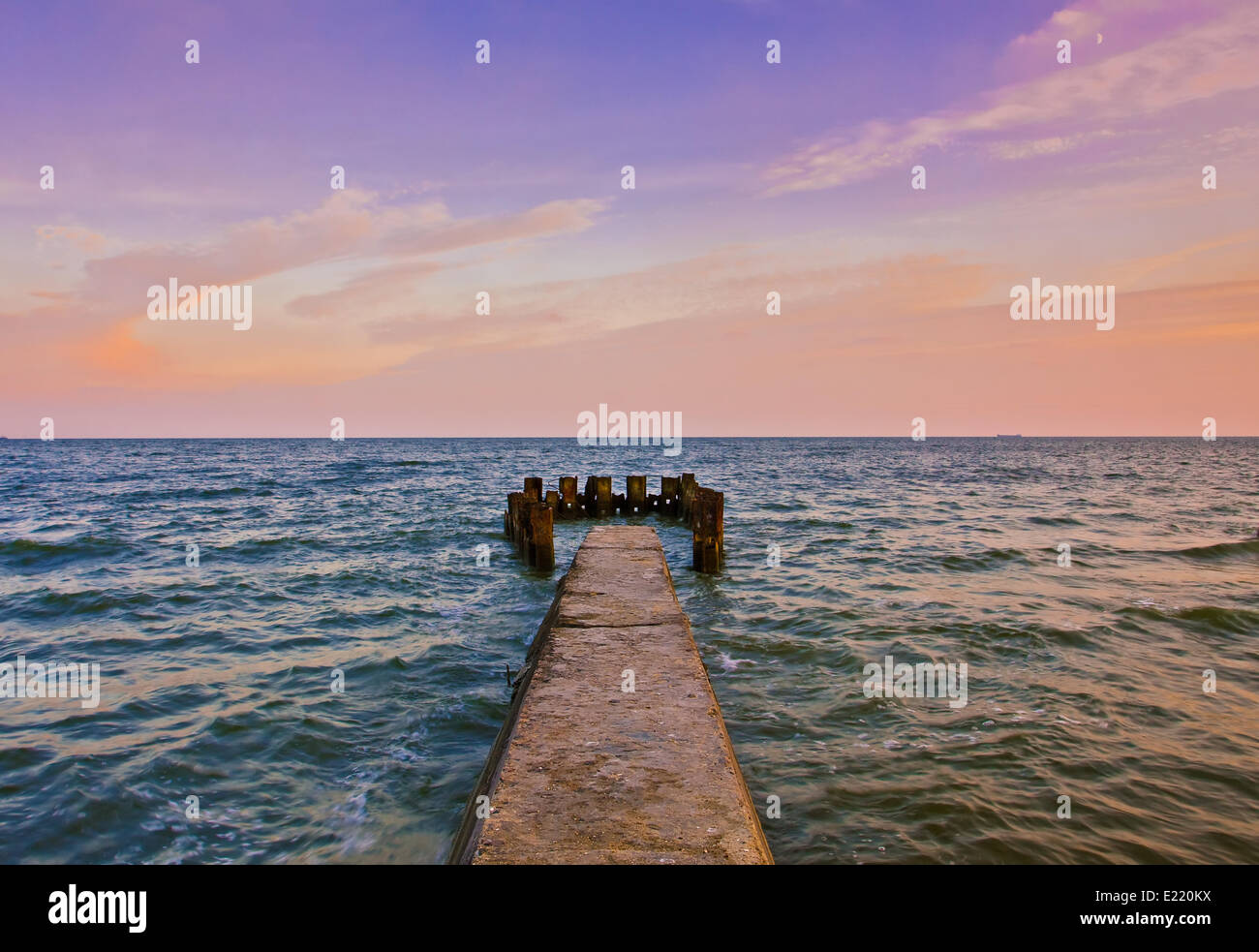 Sunset over calm sea waters Stock Photo - Alamy