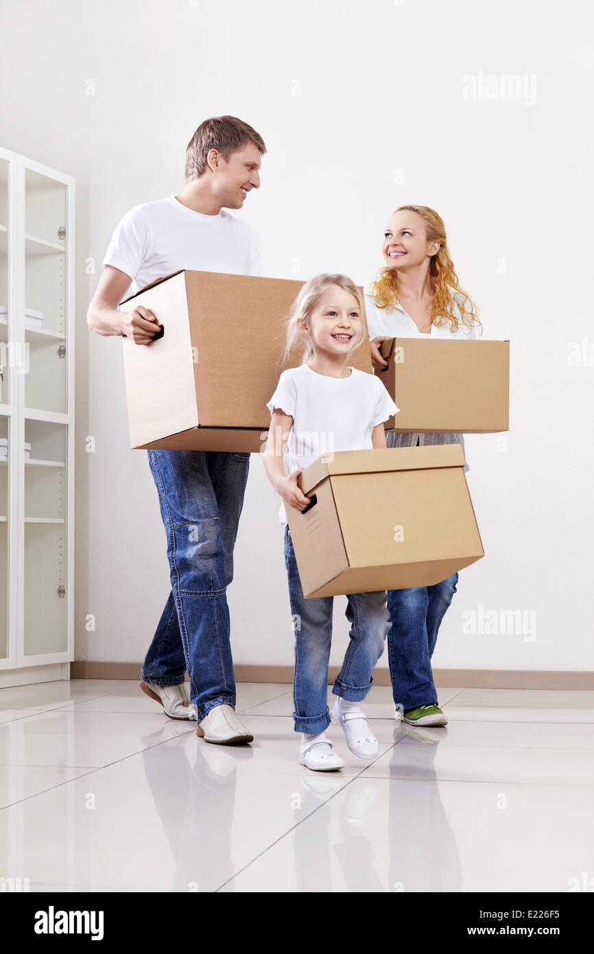 Parents and child with cardboard boxes Stock Photo - Alamy