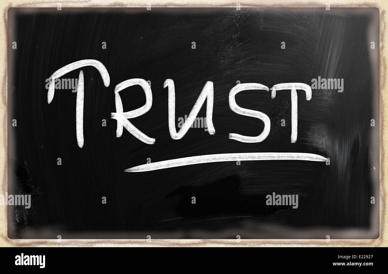 trust written with chalk on blackboard Stock Photo - Alamy