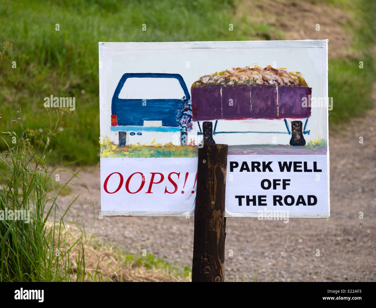 Warning sign advising drivers to park well off the road to avoid damage ...