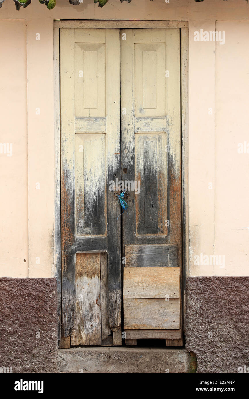 A wood panel door in a concrete wall in Cotacachi, Ecuador Stock Photo ...