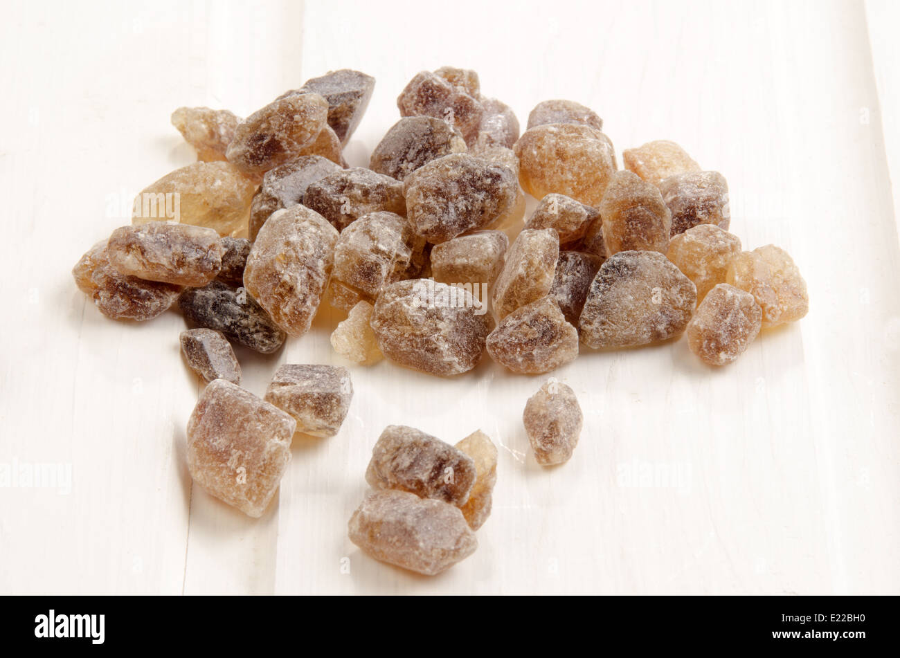 brown candy rock sugar on white wood Stock Photo - Alamy