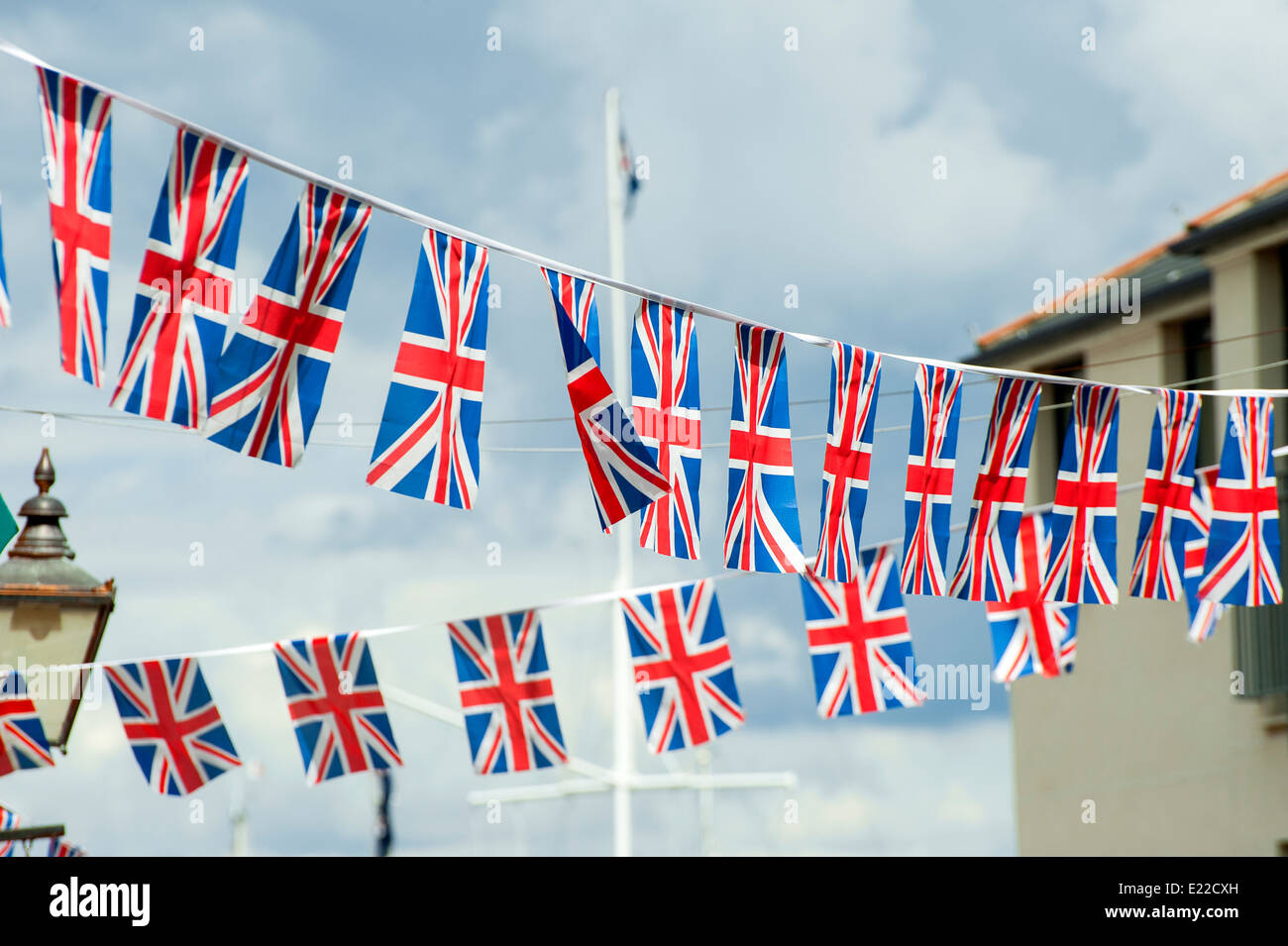 Union Jack bunting fluttering against a blue sky on a summer's day ...