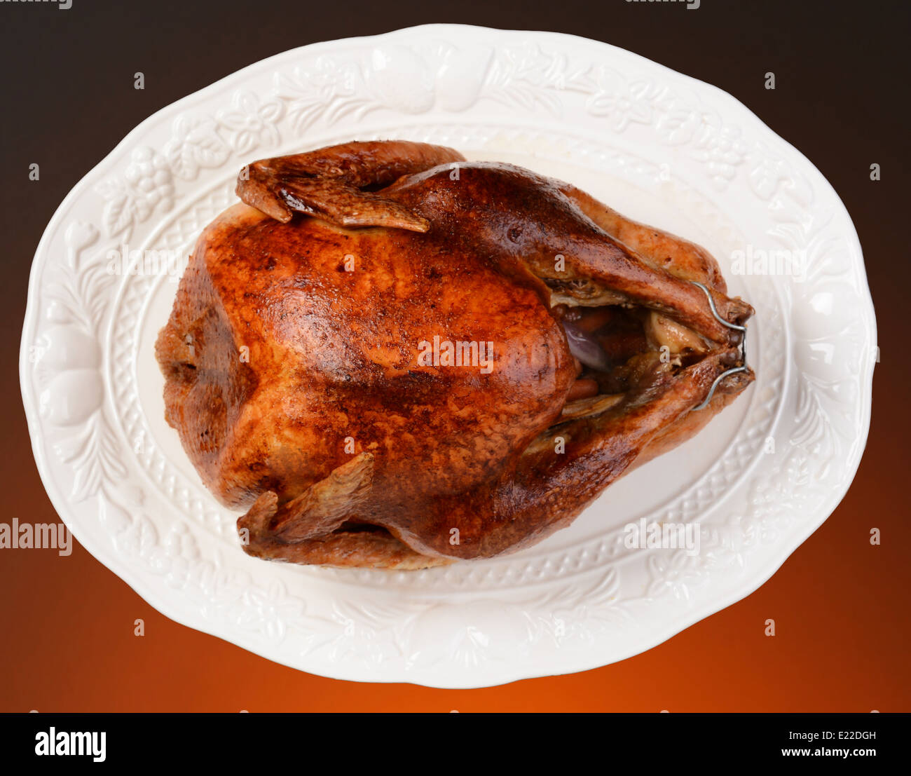 Overhead of a roasted Thanksgiving turkey on a white platter ...