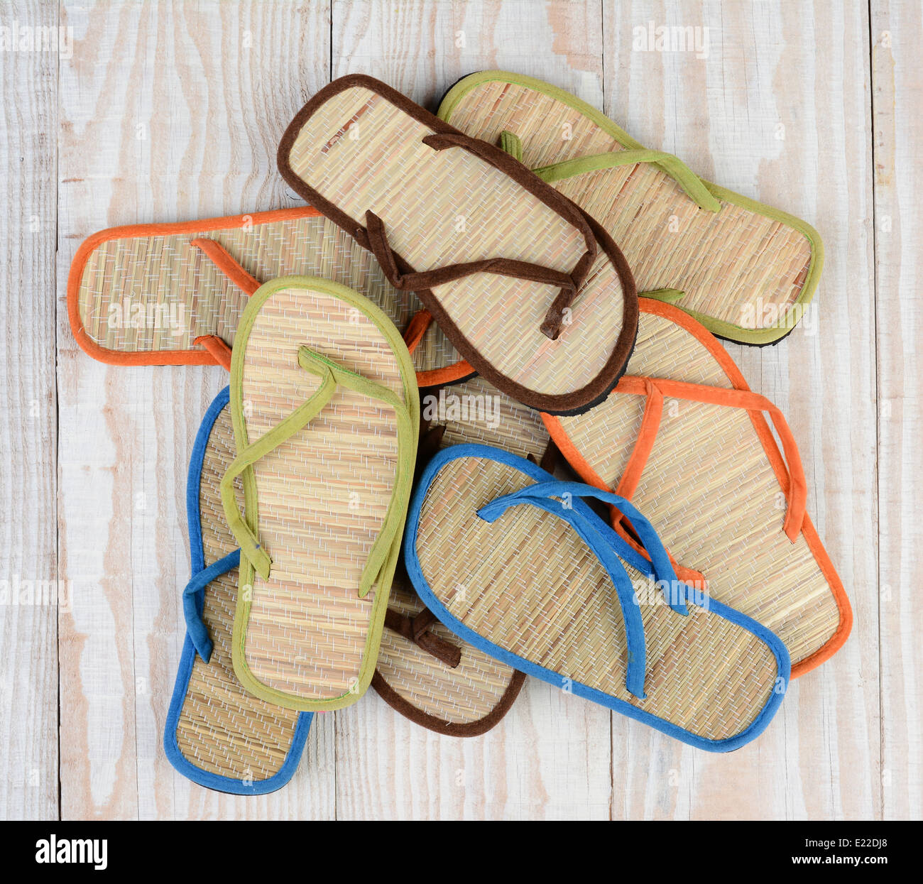 High angle shot of a group of summer beach sandals on a wooden deck ...