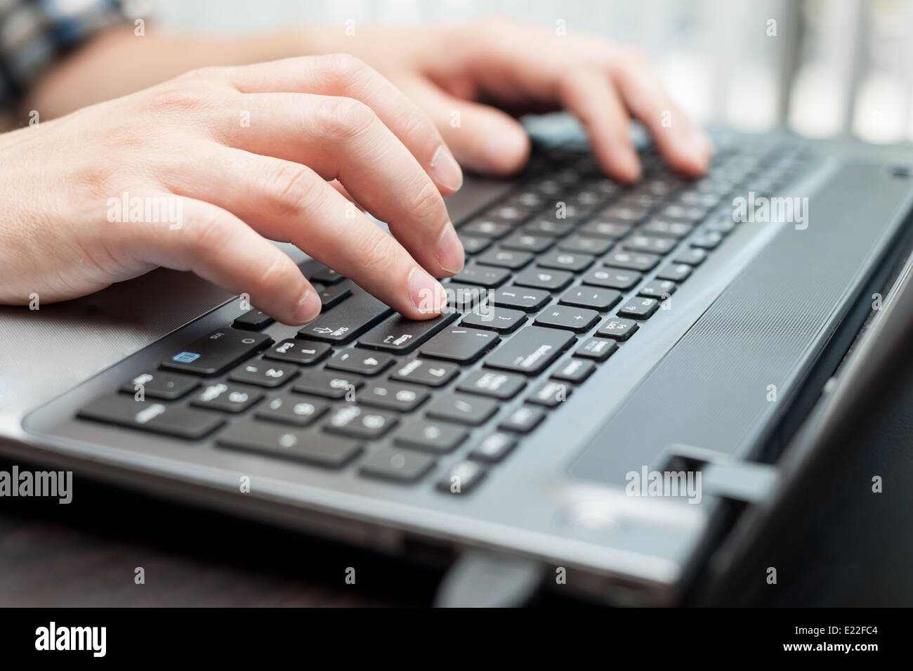 Hands of caucasian man on keyboard of laptop Stock Photo - Alamy