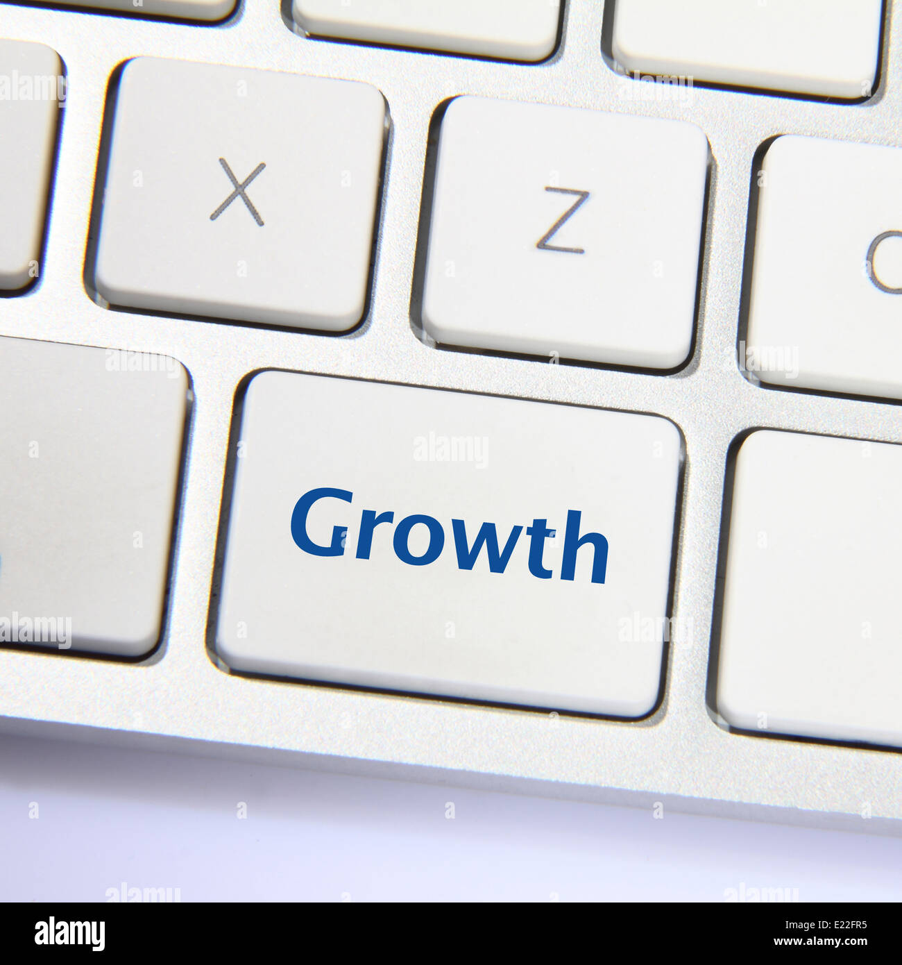 Photo of growth button on the white keyboard Stock Photo - Alamy