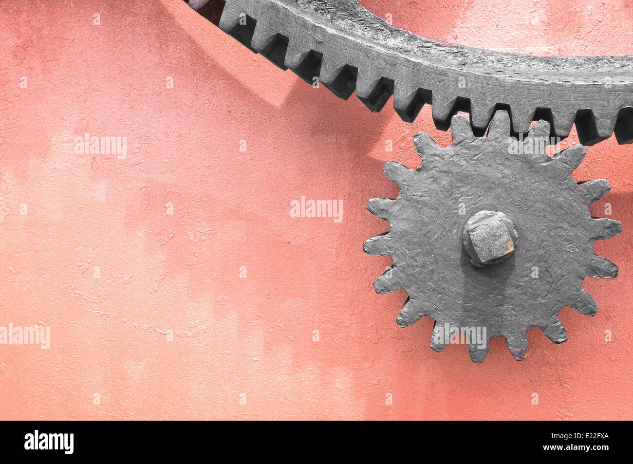 metallic gear wheel on pink wall Stock Photo - Alamy