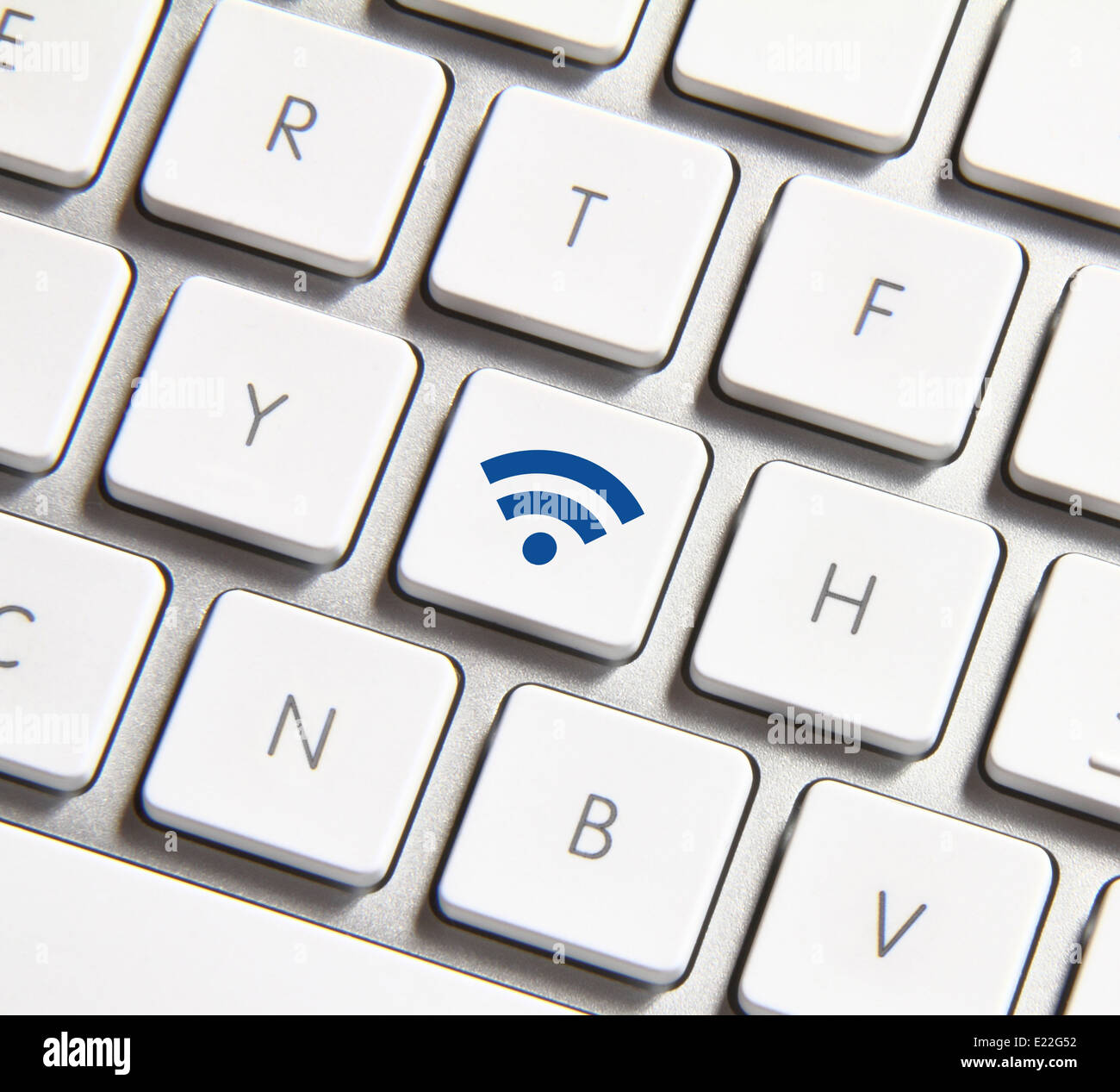 Photo of wi-fi button on the white keyboard Stock Photo - Alamy