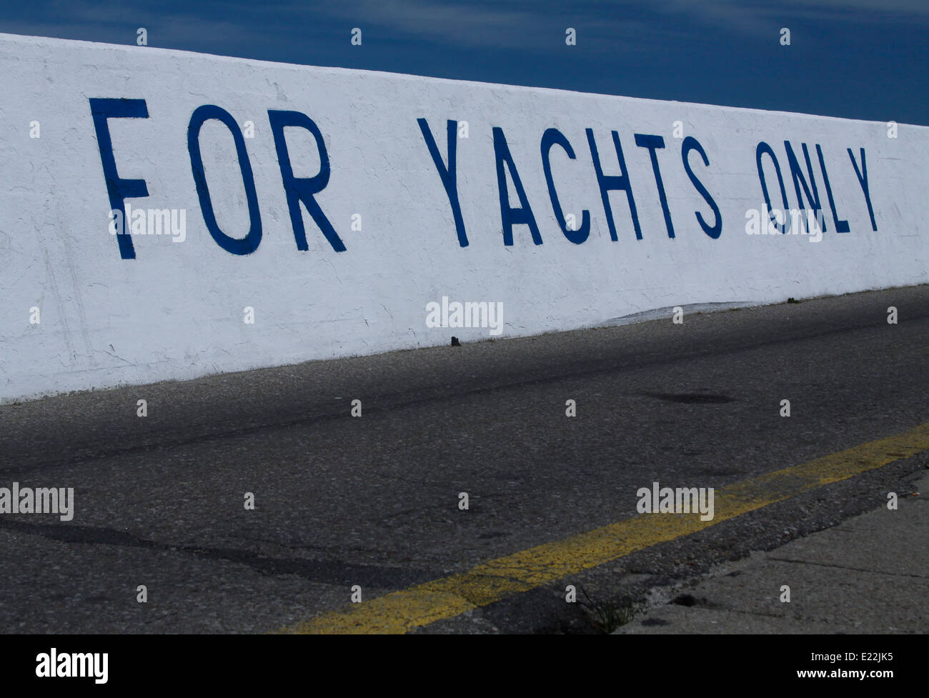 Sign "FOR YACHTS ONLY" on a wall in port Stock Photo - Alamy