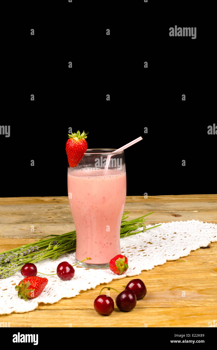 Freshly made fruity smoothie surrounded by its ingredients Stock Photo ...