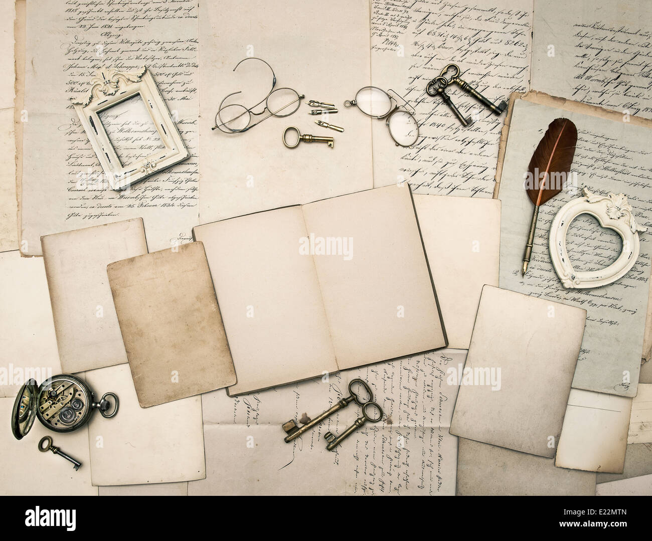 vintage writing accessories, glasses, keys, open book, old papers ...
