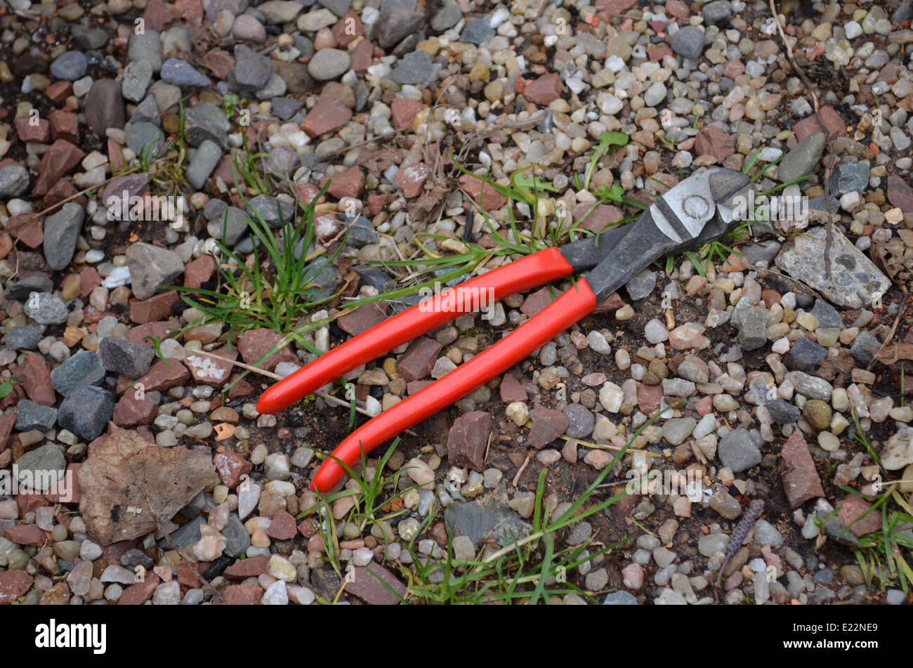 Red handled wire cutters lying on the gravel Stock Photo - Alamy