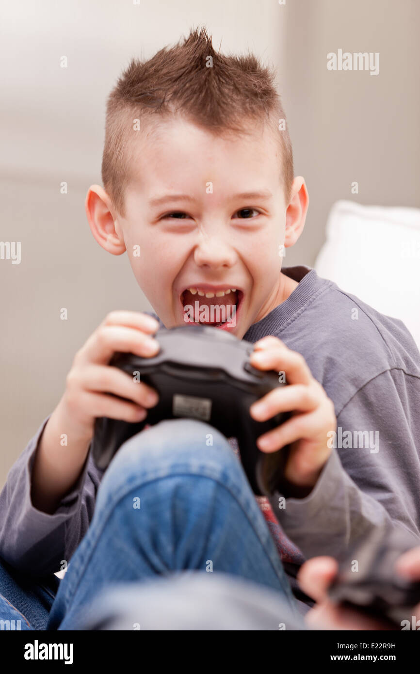 Kid having fun with video games in a brighly lit living room Stock ...