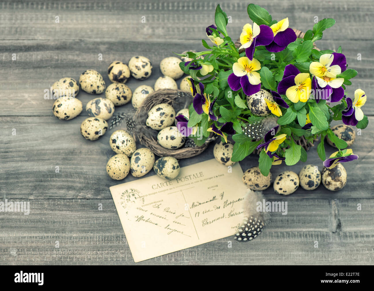 easter decoration with pansy flowers, quail eggs and greeting card ...