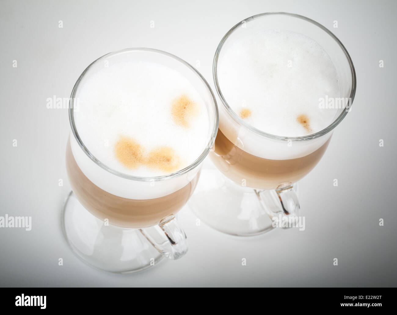Two glasses of latte coffee with milk foam Stock Photo - Alamy